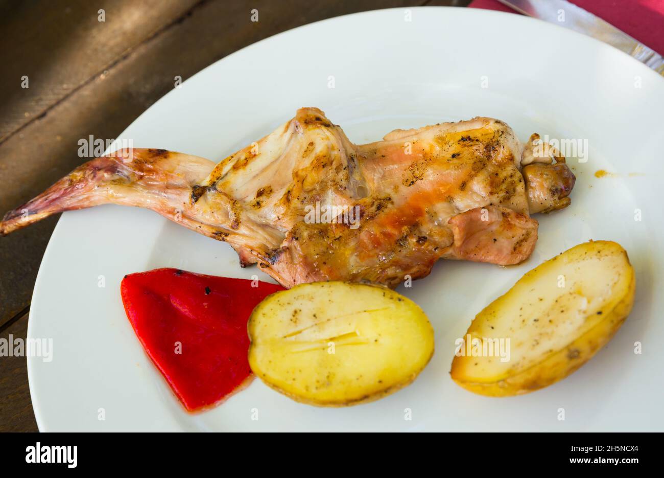 Grilled rabbit piece with vegetable garnish Stock Photo - Alamy