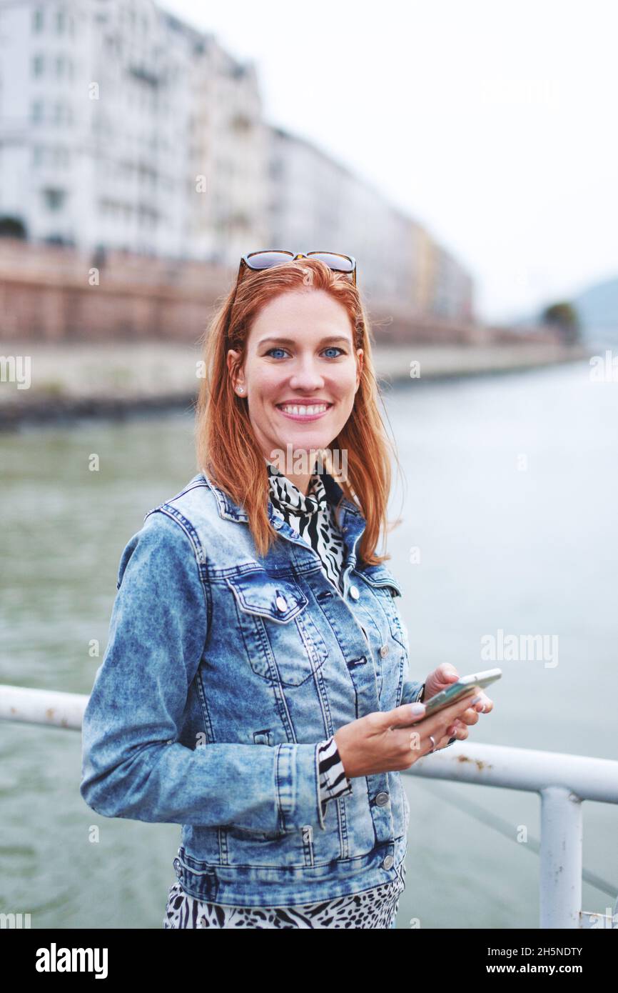 Happy Young Redhead Caucasian Woman With Mobile Phone Toothy Smile At