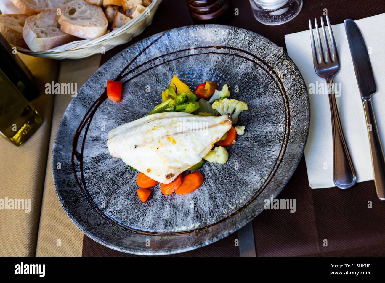 Baked dorado fish fillet with broccoli, carrot and pepper Stock Photo ...