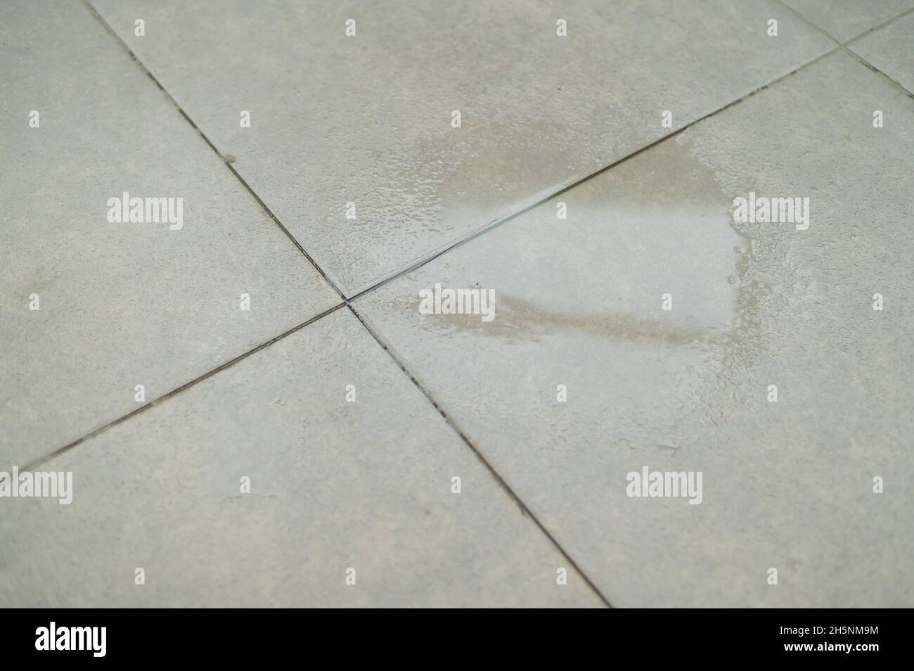Water drips onto the tiled floor Stock Photo - Alamy