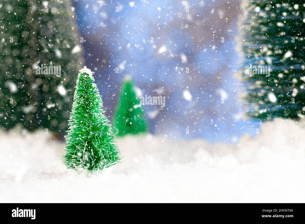 New year greeting card. Little toy firs in the snow. Snowing Stock ...