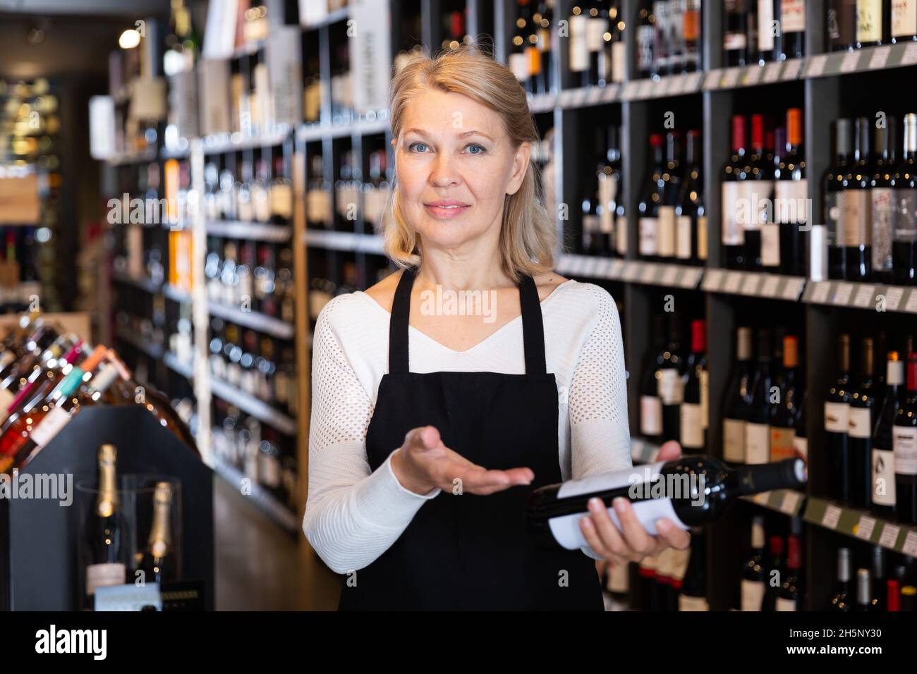 Female vintner recommending wine Stock Photo - Alamy