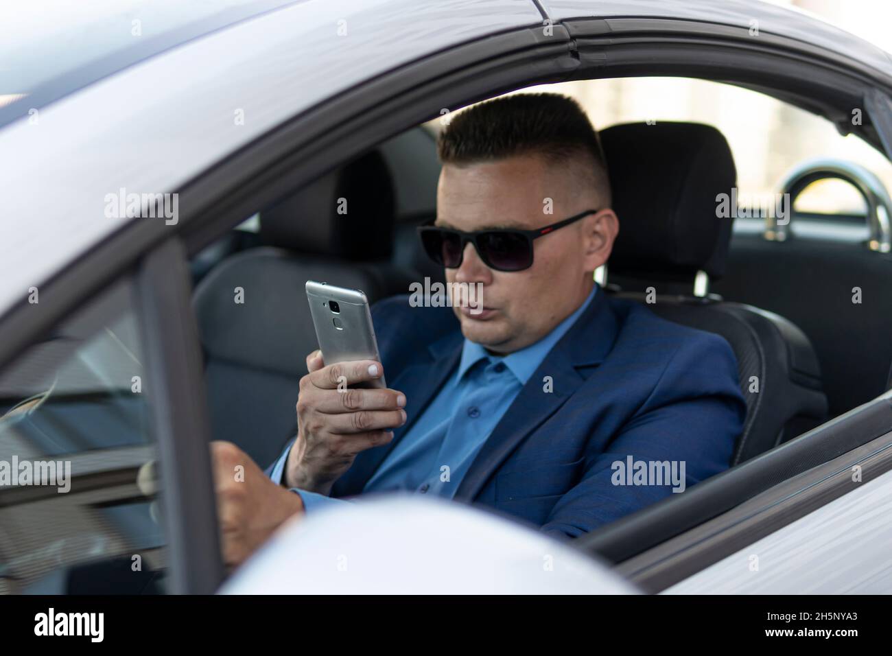 transportation and vehicle concept man using phone while driving car ...