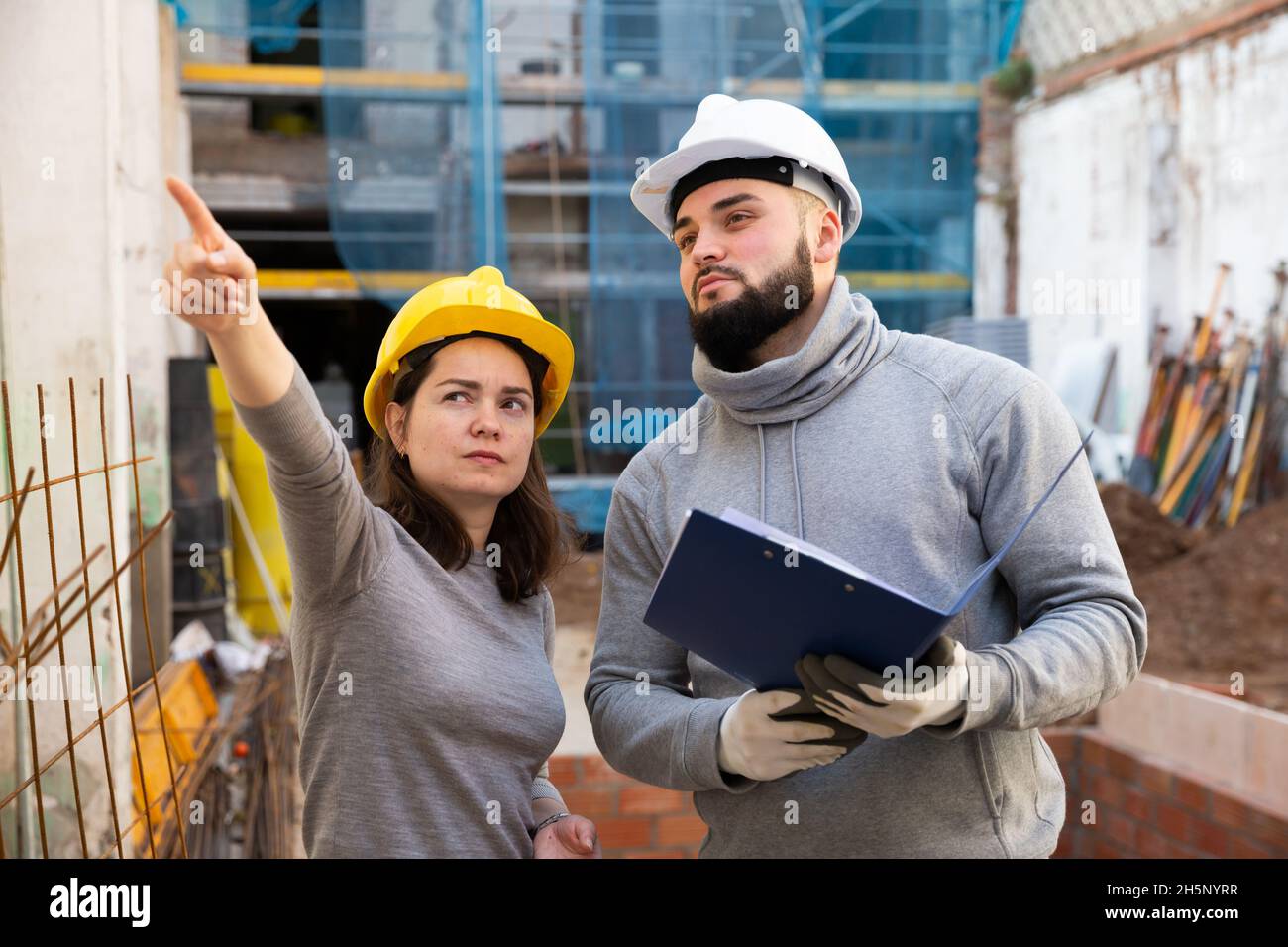 Engineers inspecting process of building overhaul Stock Photo - Alamy