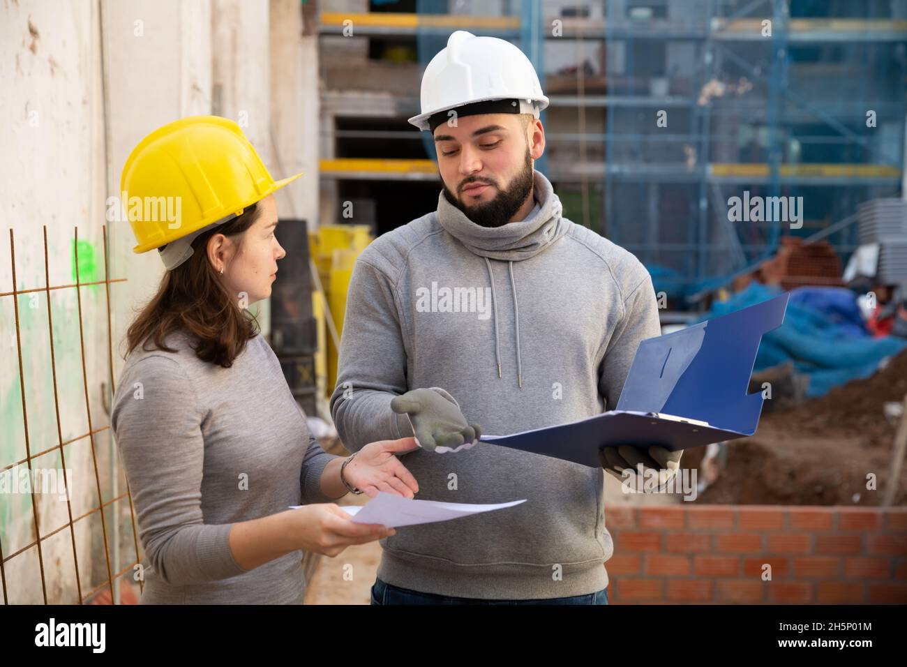 Engineers inspecting process of building overhaul Stock Photo - Alamy