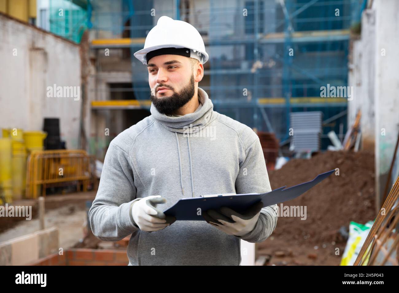 Engineer planning renovation works at building site Stock Photo - Alamy