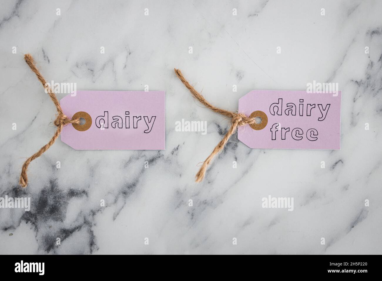 dairy and dairy-free labels side by side on top of on marble table ...