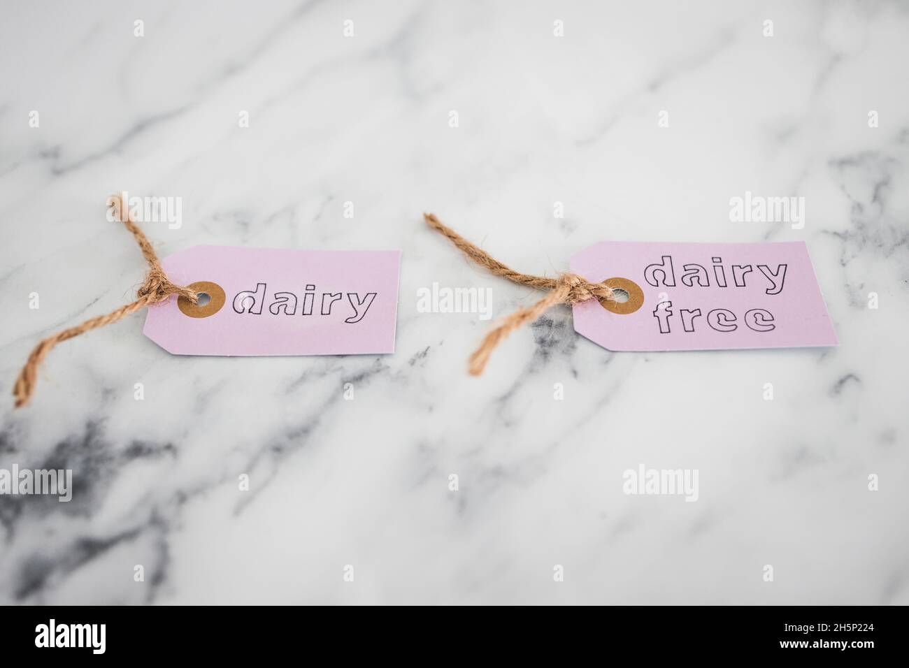 dairy and dairy-free labels side by side on top of on marble table ...