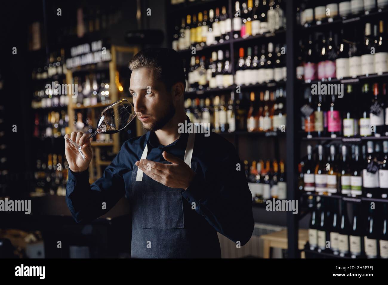 Winemaker sommelier man sniffing aroma red wine in glass background ...