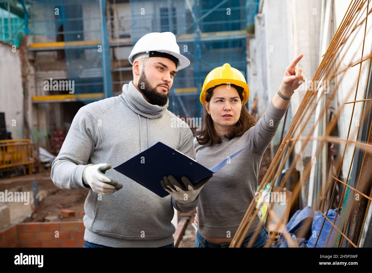 Engineers inspecting process of building overhaul Stock Photo - Alamy