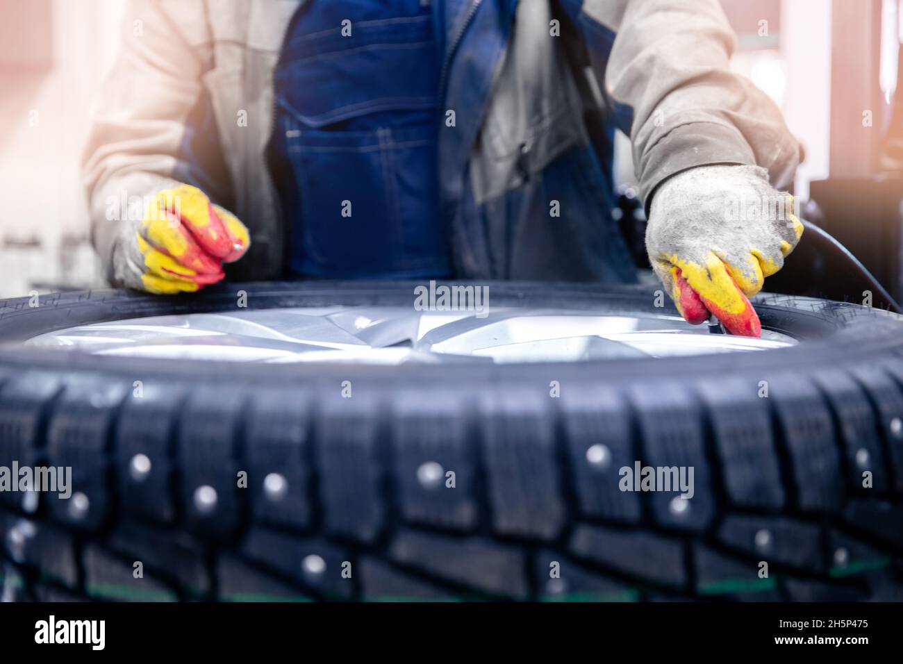 Filling car wheel with air, replacing summer tires, removing puncture ...