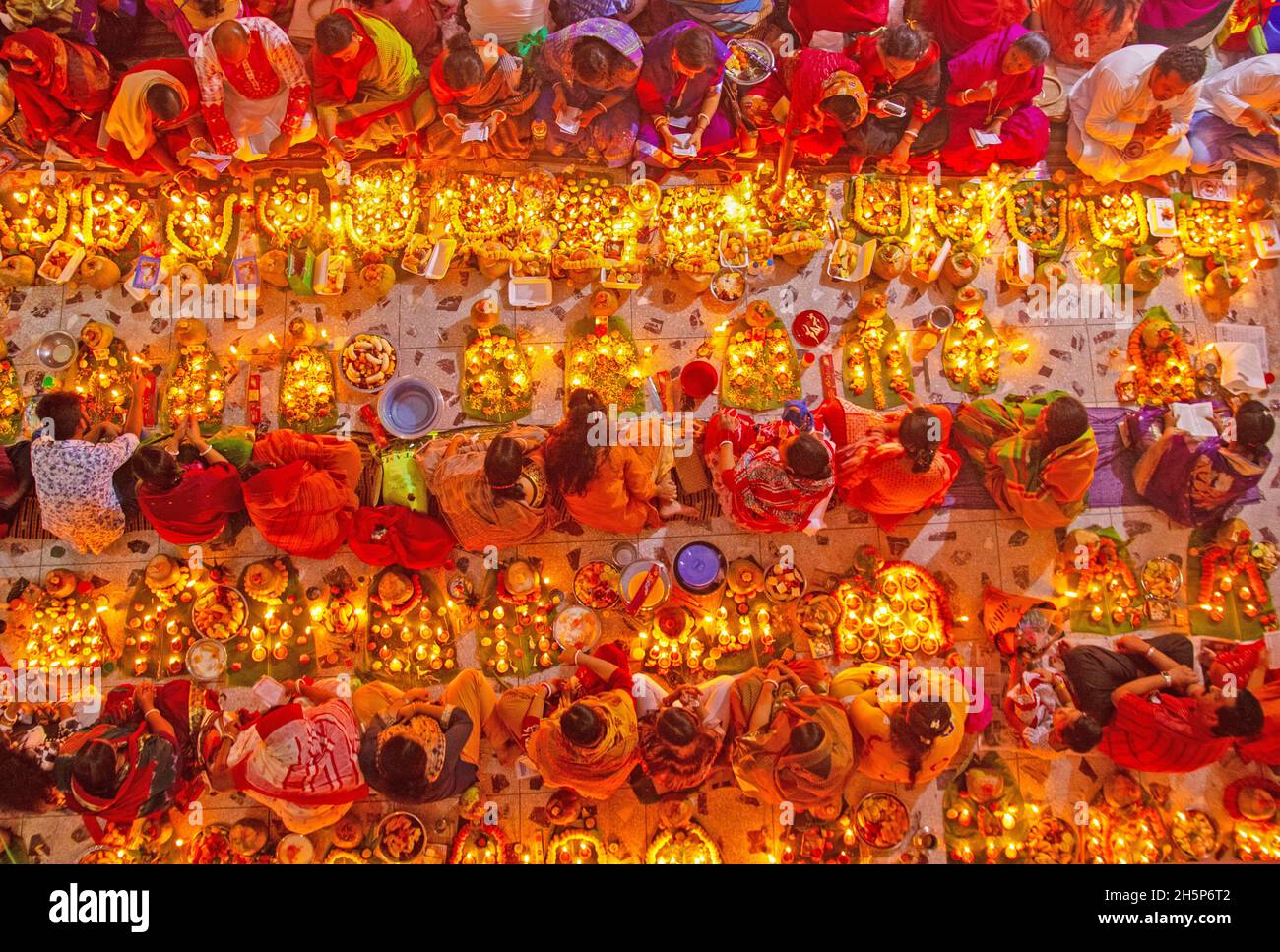 Hindu devotees sit with Prodip (lights) and pray to God for the welfare ...