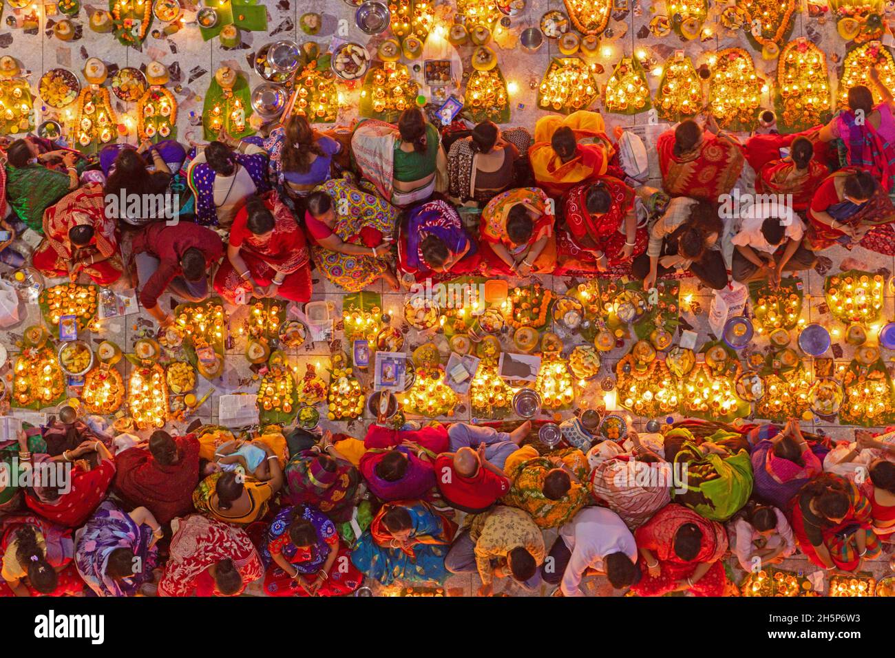 Hindu devotees sit with Prodip (lights) and pray to God for the welfare ...
