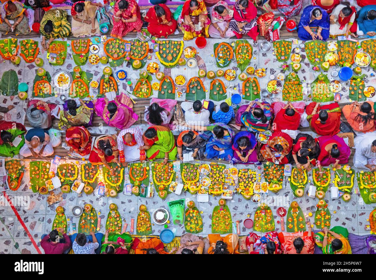 Hindu devotees sit with Prodip (lights) and pray to God for the welfare ...