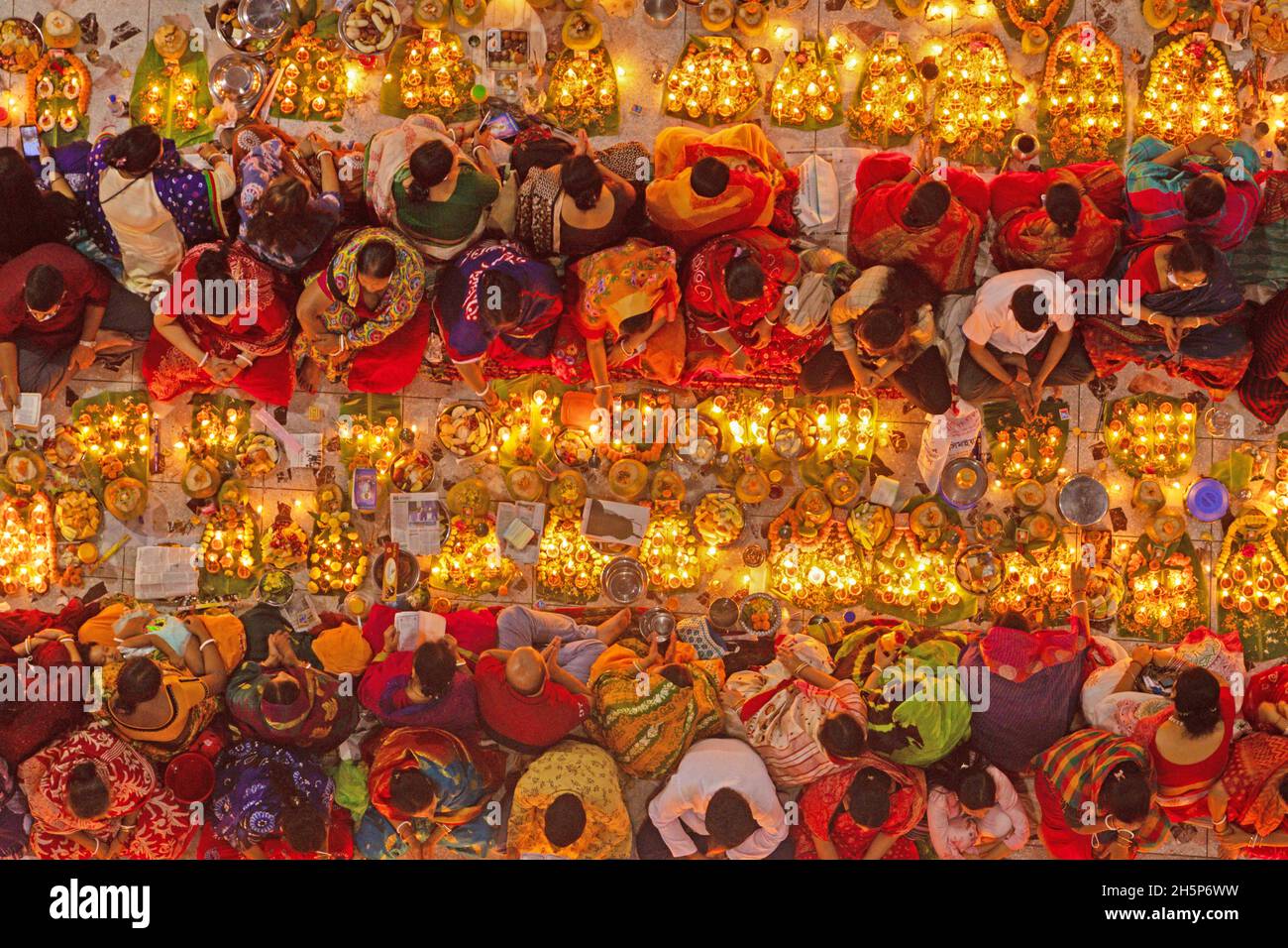 Hindu devotees sit with Prodip (lights) and pray to God for the welfare ...