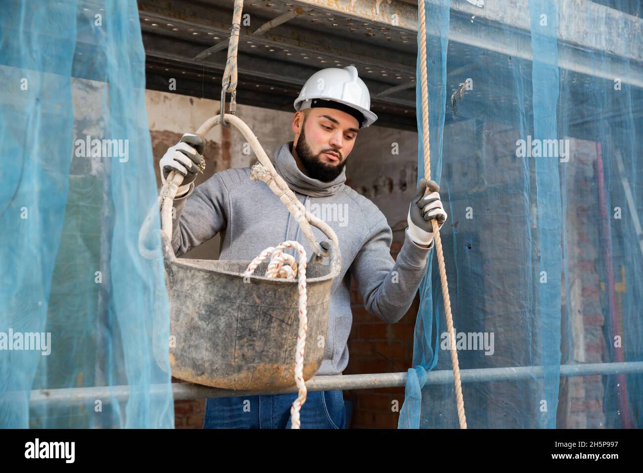 Lowering down bucket hi-res stock photography and images - Alamy