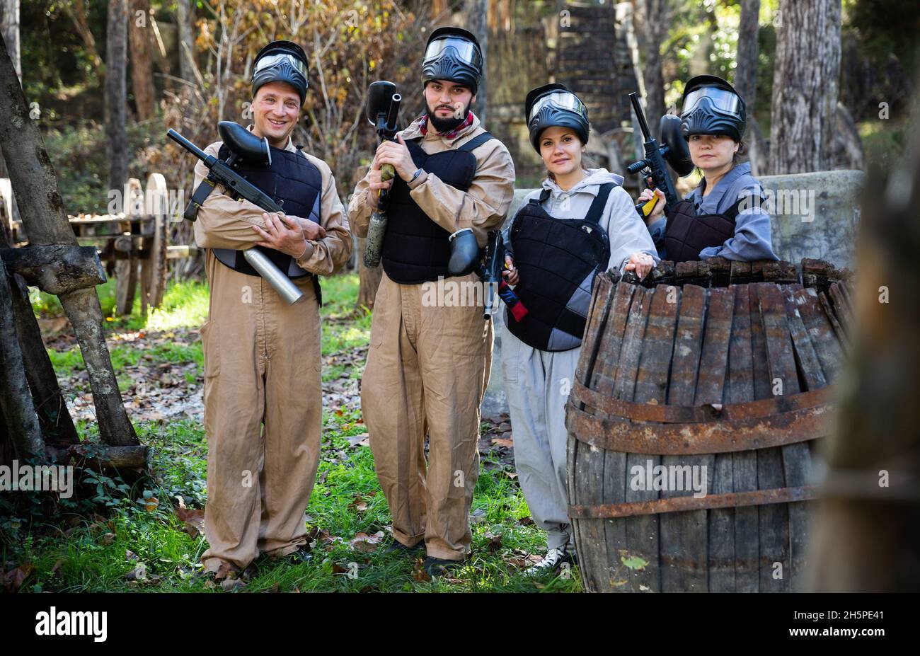 Friends posing on paintball field Stock Photo - Alamy