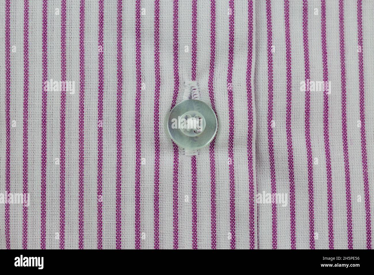Close-up of white button on striped red and white shirt pattern Stock ...