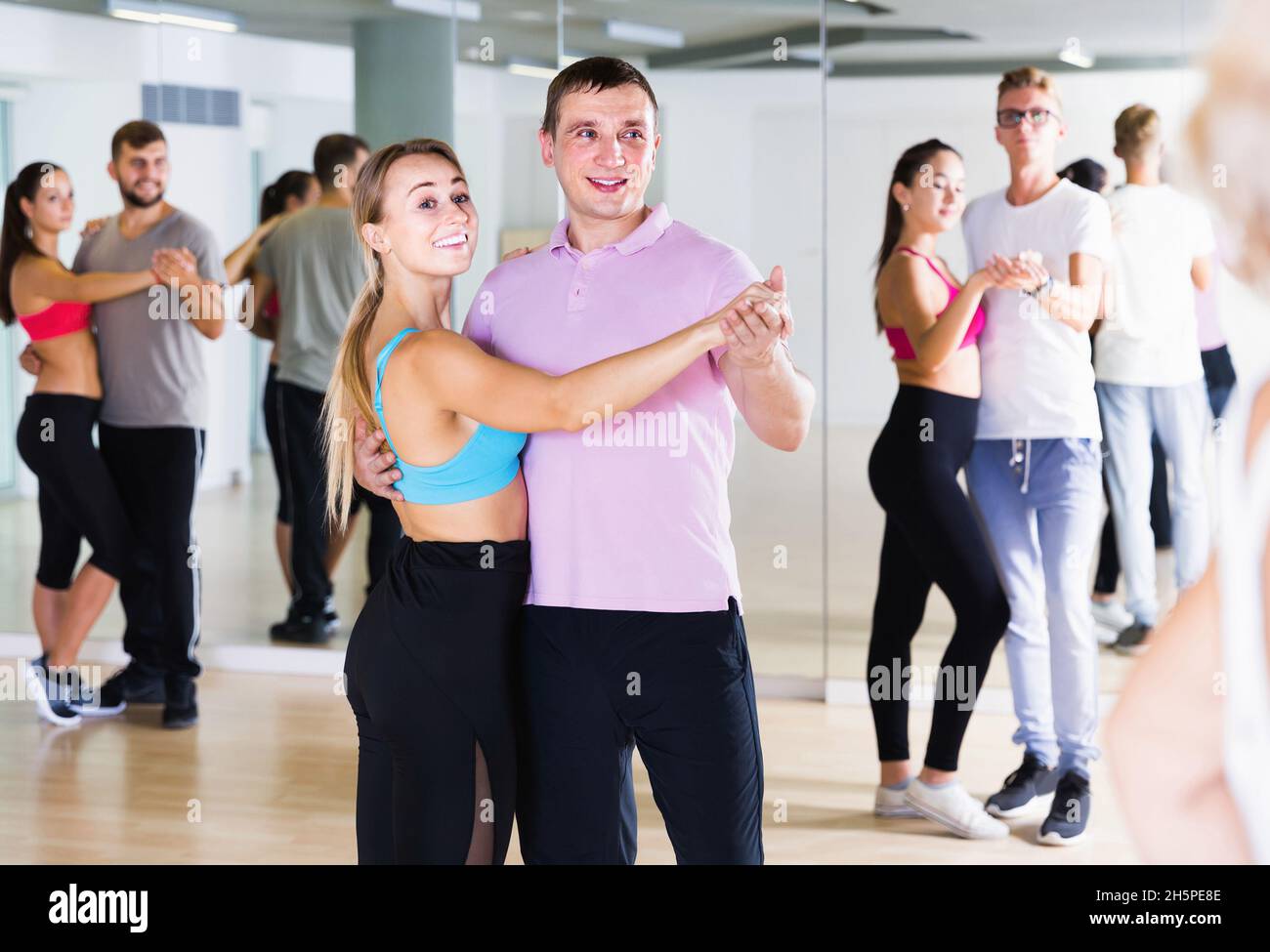 Dancing couples learning salsa at dance class Stock Photo - Alamy