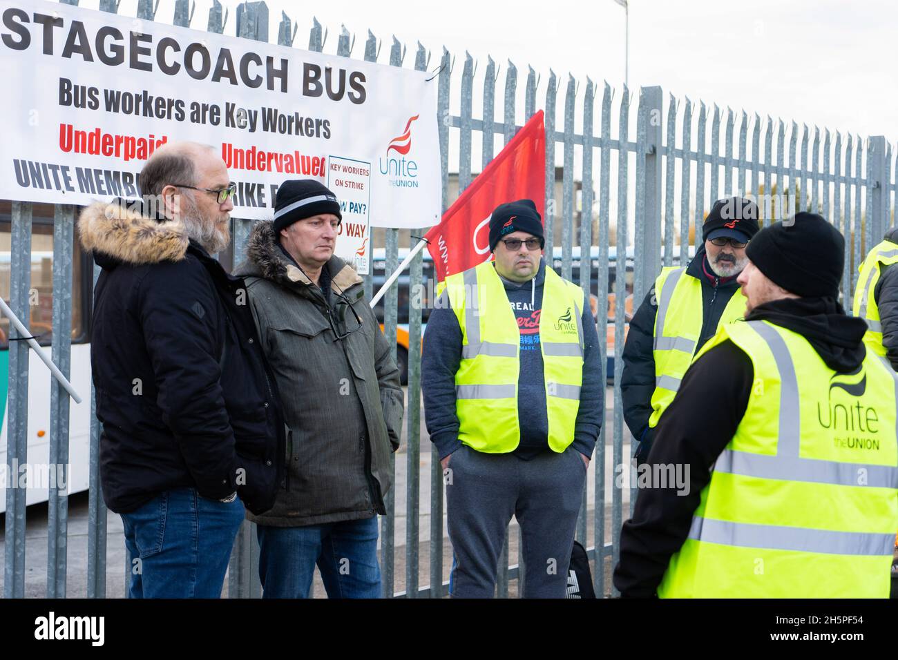 Striking bus drivers stand on a picket line outside the main gate of ...