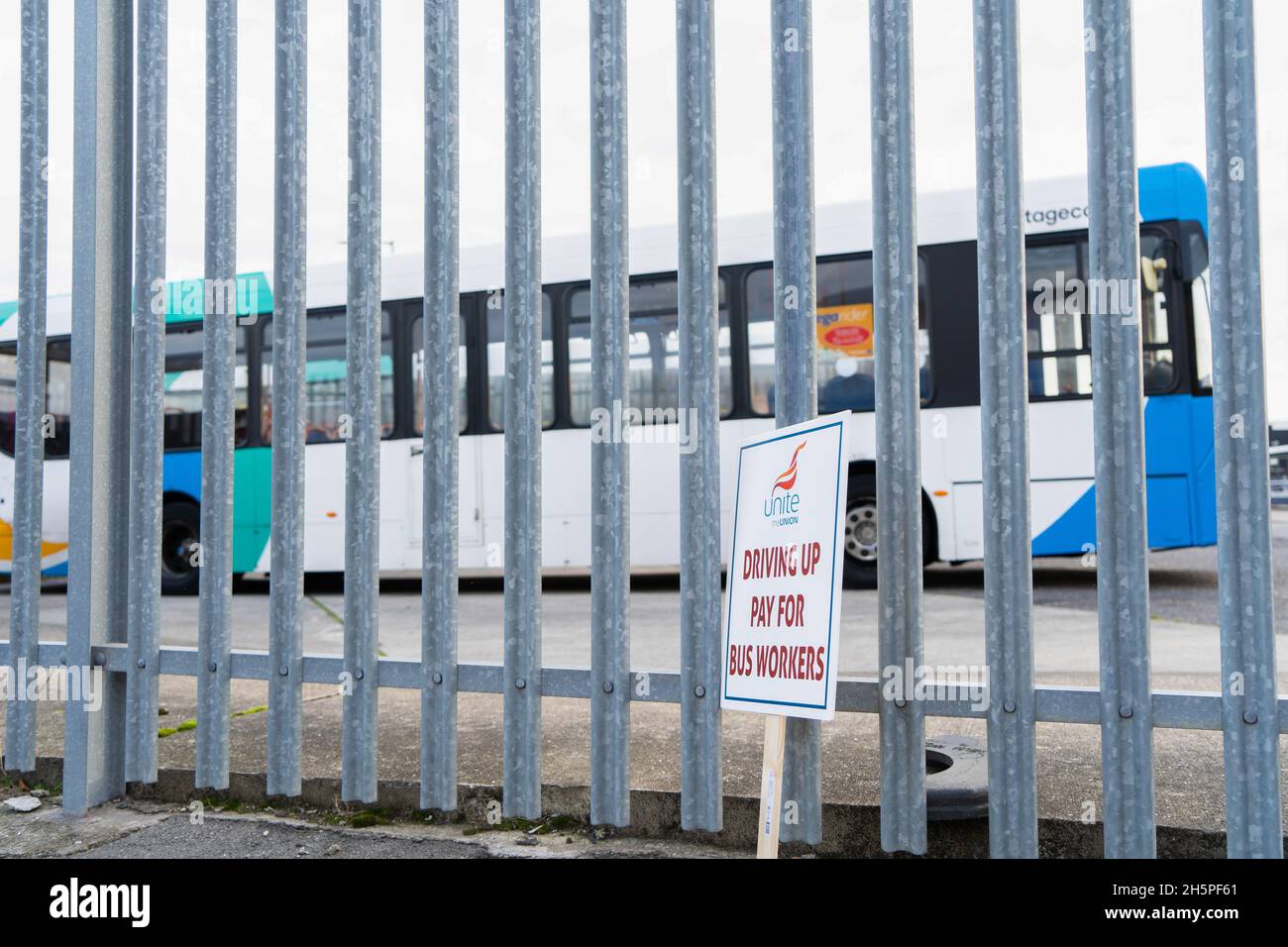 A placard used by striking bus drivers leans against the bus depot ...