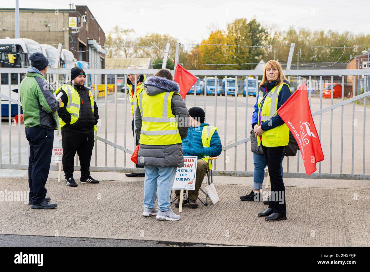Striking bus drivers stand on a picket line in front of the main gate ...