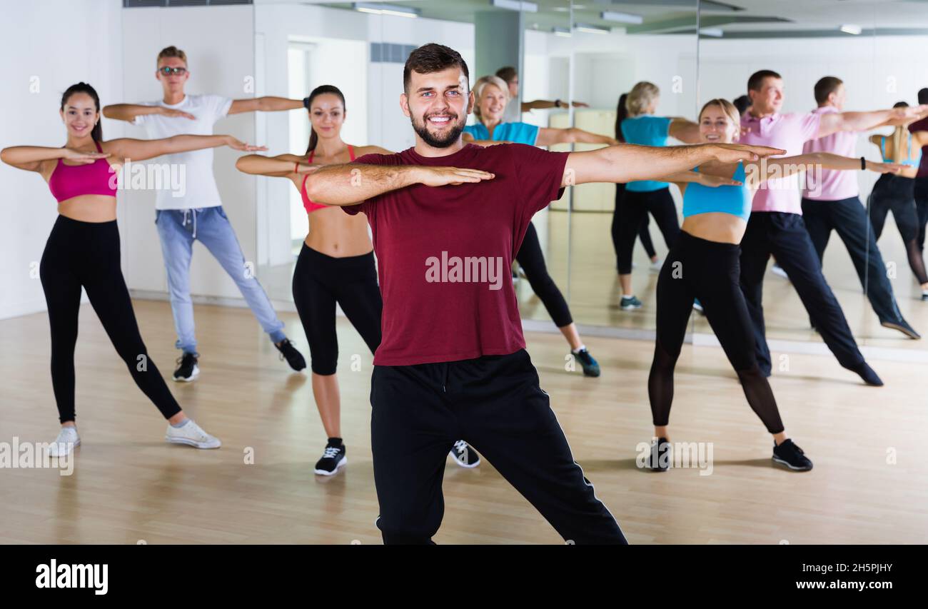 Positive women and men dancing in dance studio Stock Photo - Alamy