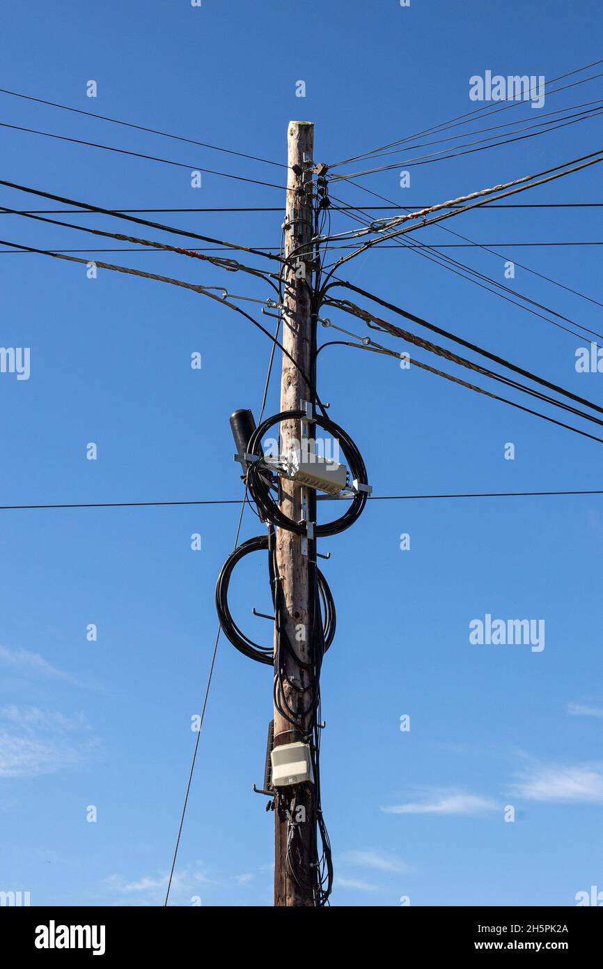 Metal post with electric wires in the blue sky background Stock Photo ...