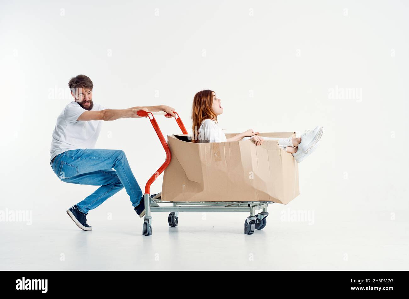 a young couple ride a cart entertainment isolated background Stock ...