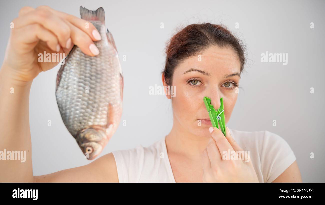 Caucasian woman with a clothespin on her nose because of the disgusting ...