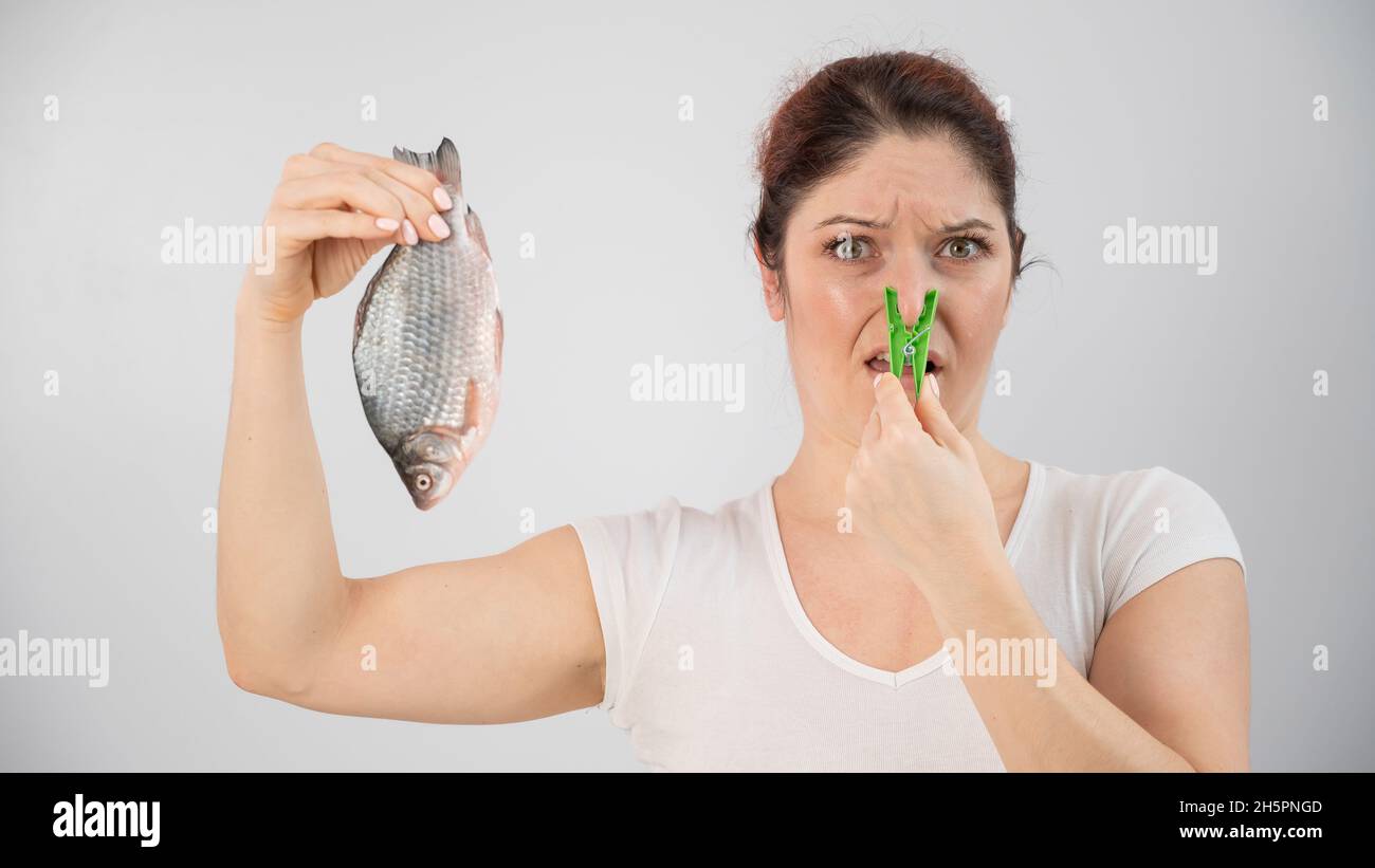 Caucasian woman with a clothespin on her nose because of the disgusting ...