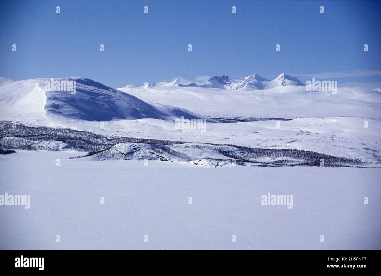Scandinavian mountains in June, analog. Wet, snowy uphill, and ...