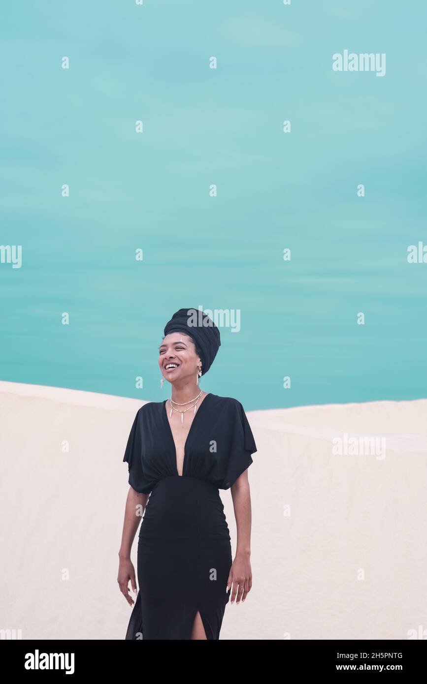 Happy woman seen outdoors with colorful sky in background Stock Photo ...