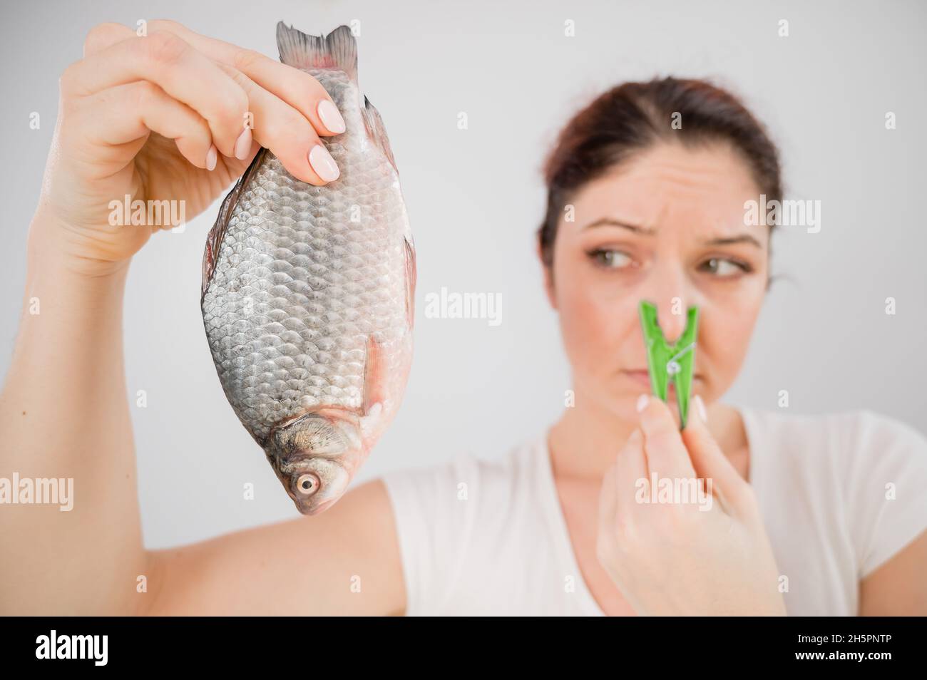 Caucasian woman with a clothespin on her nose because of the disgusting ...