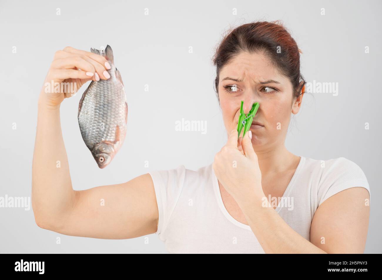 Caucasian woman with a clothespin on her nose because of the disgusting ...
