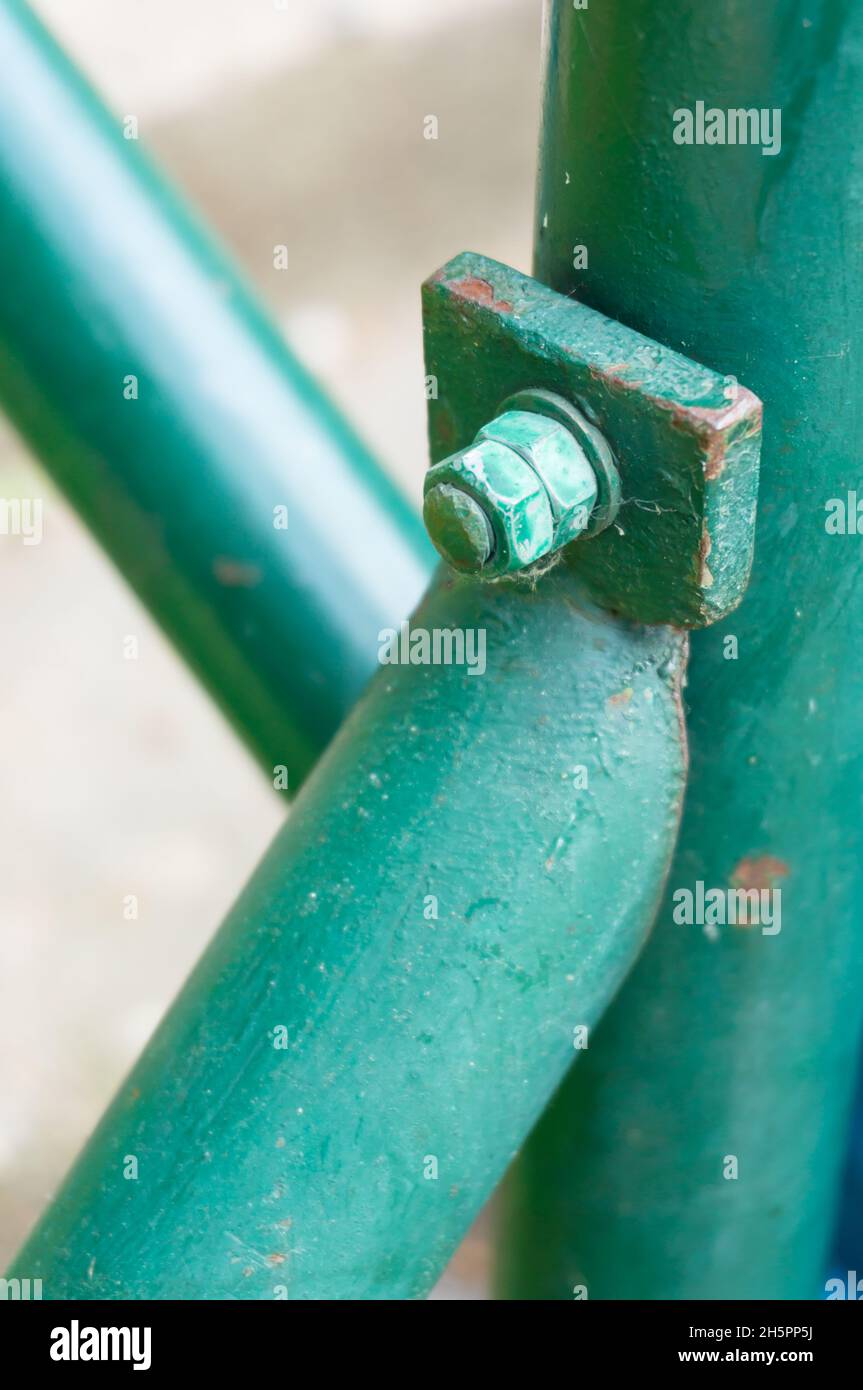 Vertical shot of bolt in a green pole Stock Photo - Alamy