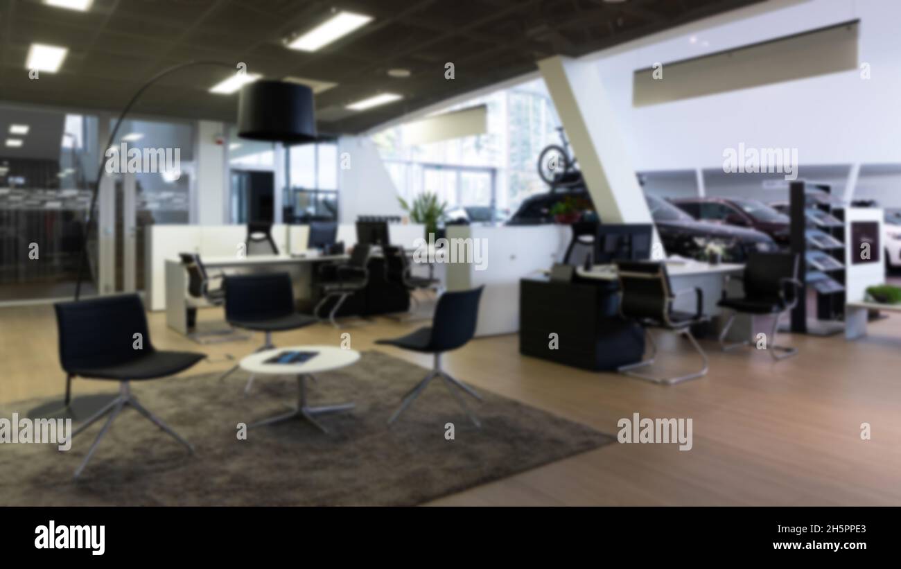 reception of a dealership car showroom of premium cars, photo with blur ...