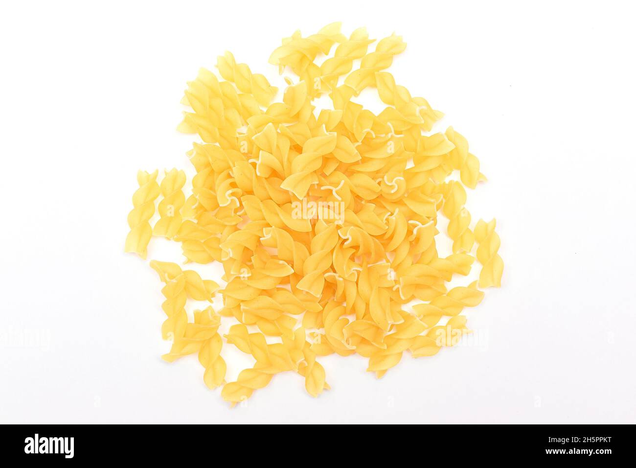 A Heap of Uncooked Fusilli Pasta Scattered on White Table. Raw and Dry ...