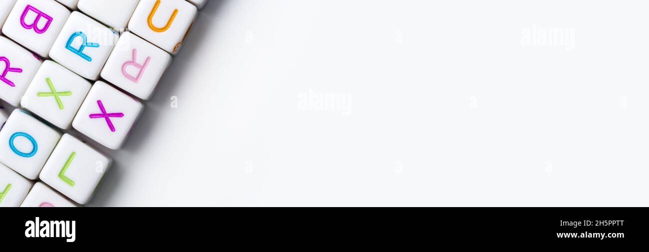 Lots of colorful decorative cubes with letters on white background. The ...