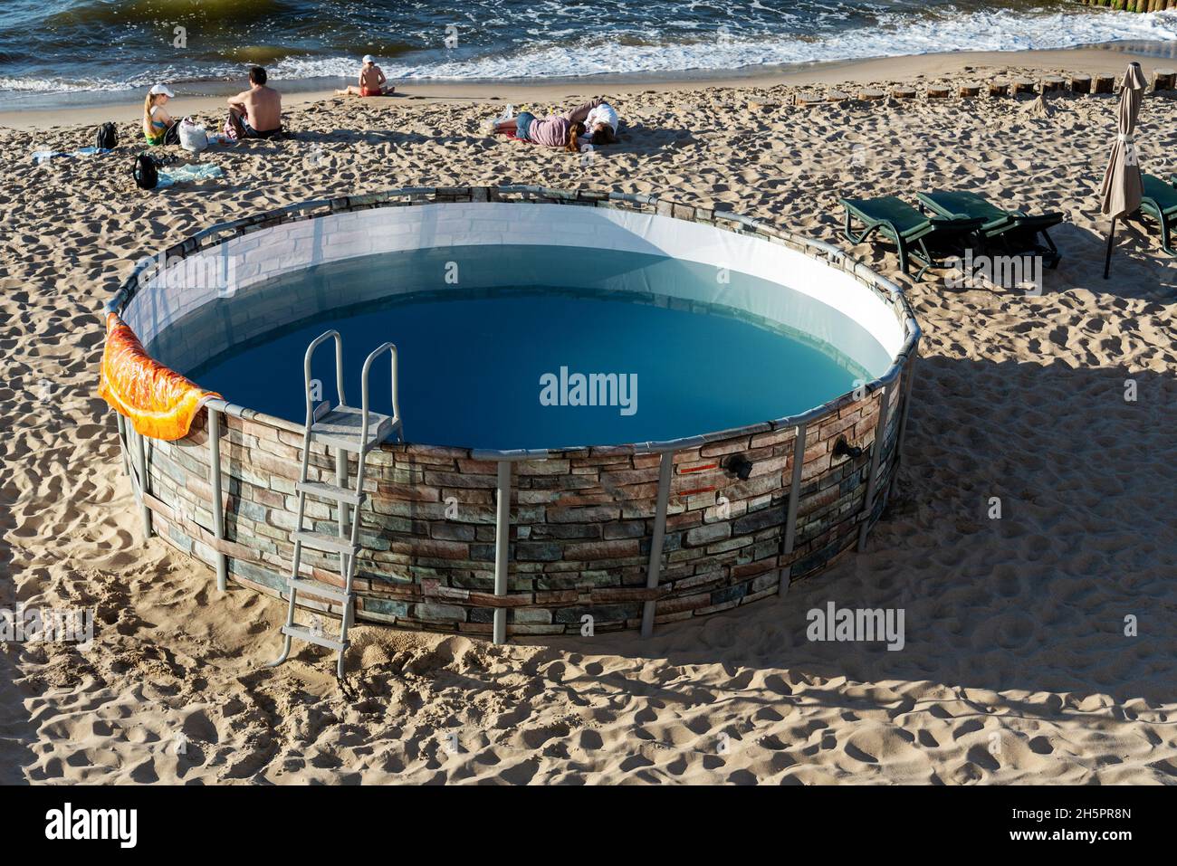 Round pool near the sea, on the beach for vacationers. The concept of ...