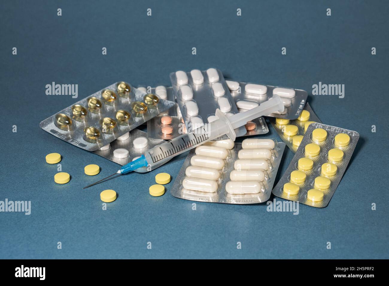 A lot of pills and syringe with injection as against Covid-19. Insulin ...
