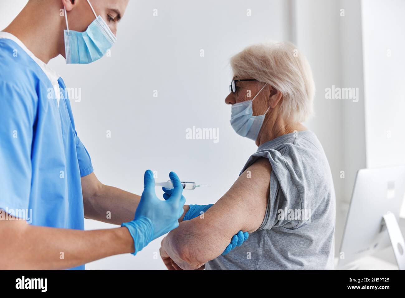 elderly woman next to the doctor arm injection vaccine passport ...