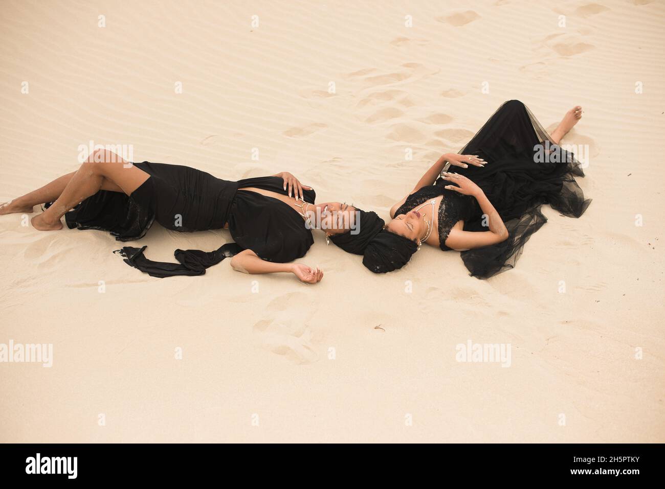 Woman seen laying on sand shot from high angle Stock Photo - Alamy