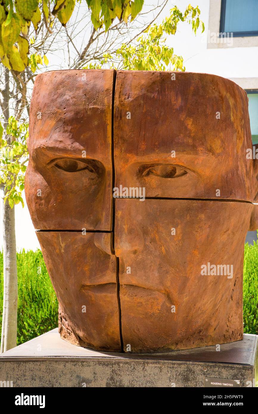 Big bronze statue of a male face in the park Stock Photo - Alamy