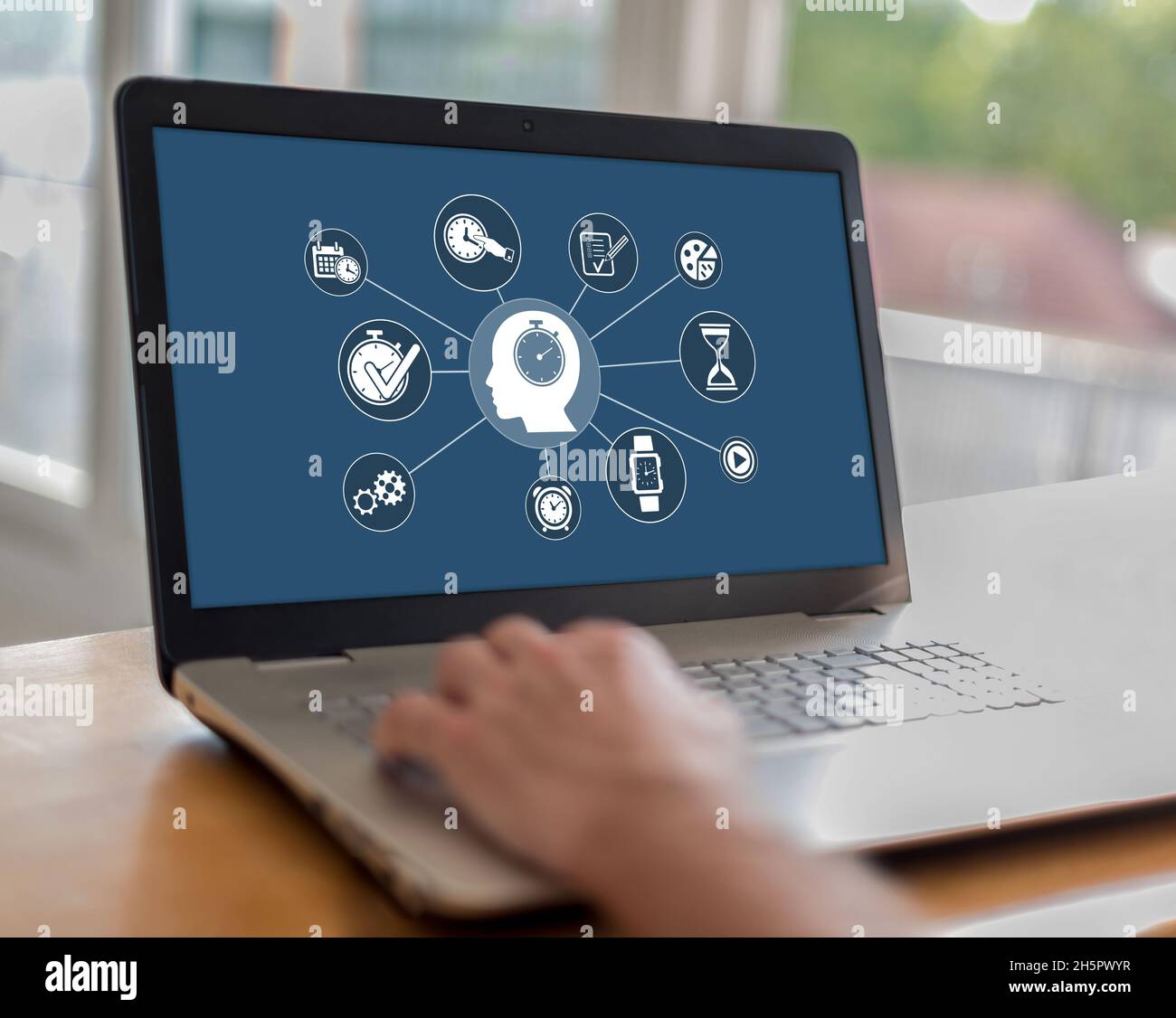 Man using a laptop with time management concept on the screen Stock ...