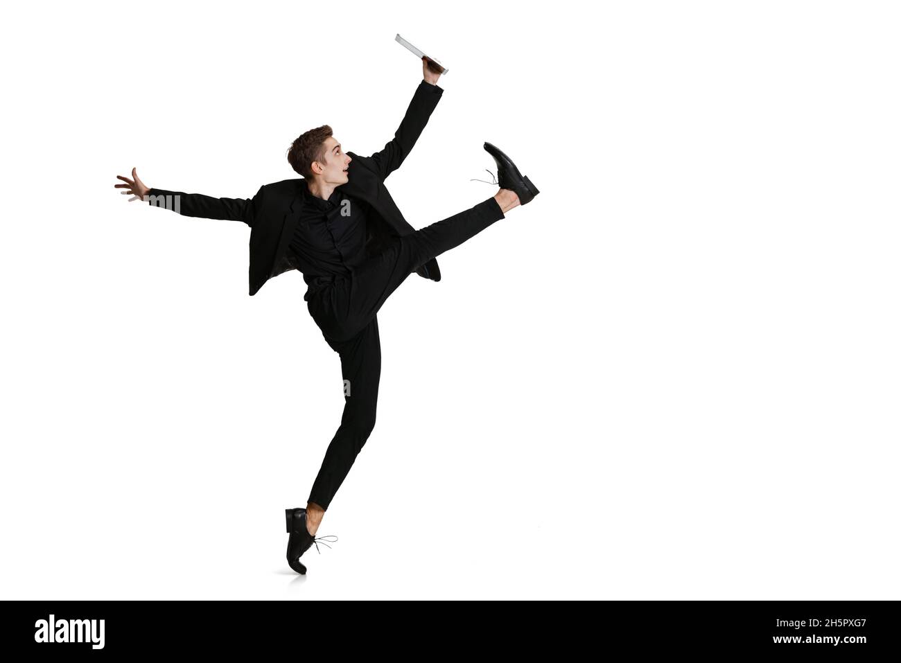Full-length portriat of young man in black business suit dancing ...