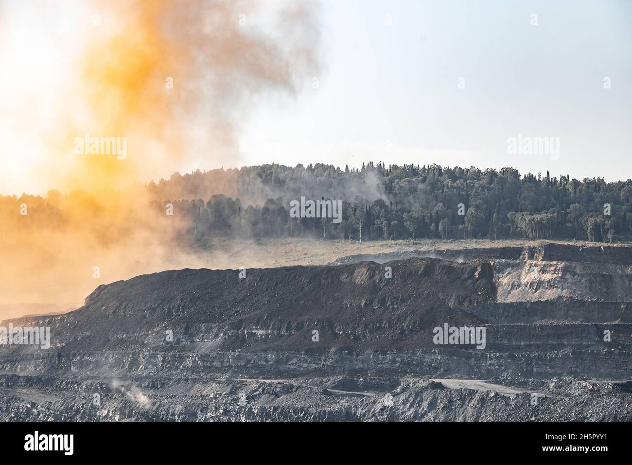 Explosive works on open pit coal mine industry. Dust and puffs of smoke ...