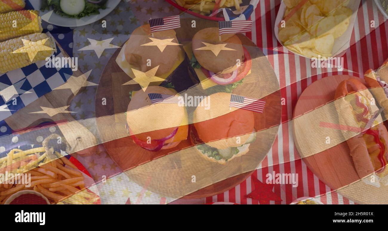Image of flag of united states of america moving over festive snacks ...