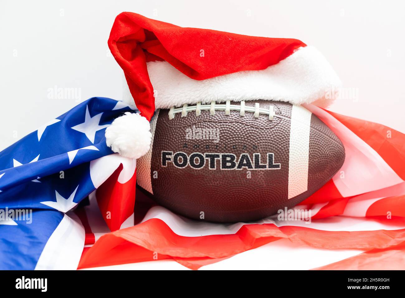 A souvenir ball for rugby or american football in a red santa claus hat ...