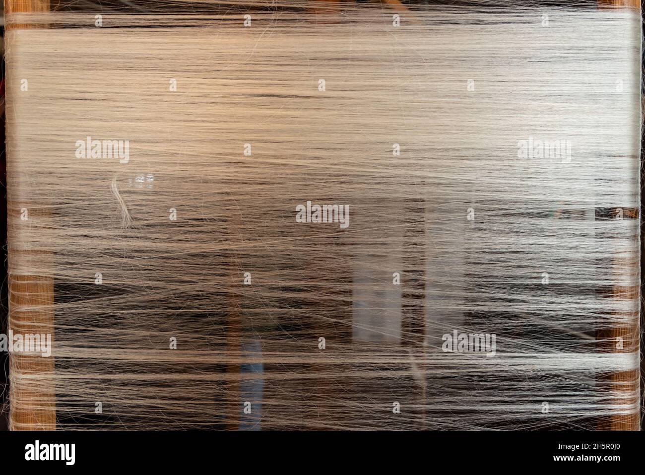 Thin white woven threads on weaver loom in folk museum Stock Photo - Alamy